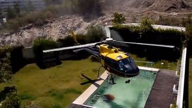WATCH: Helicopter Raids Pool to Fight Fire